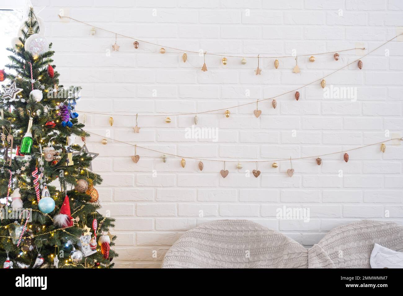 Christmas tree in white interior of a house with loft-style brick walls ...