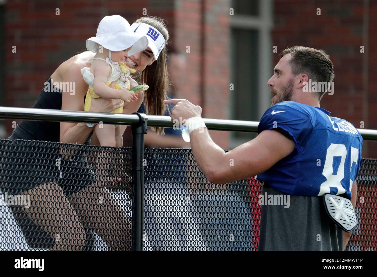 New York Giants running back Rhett Ellison, right, talks to his wife ...