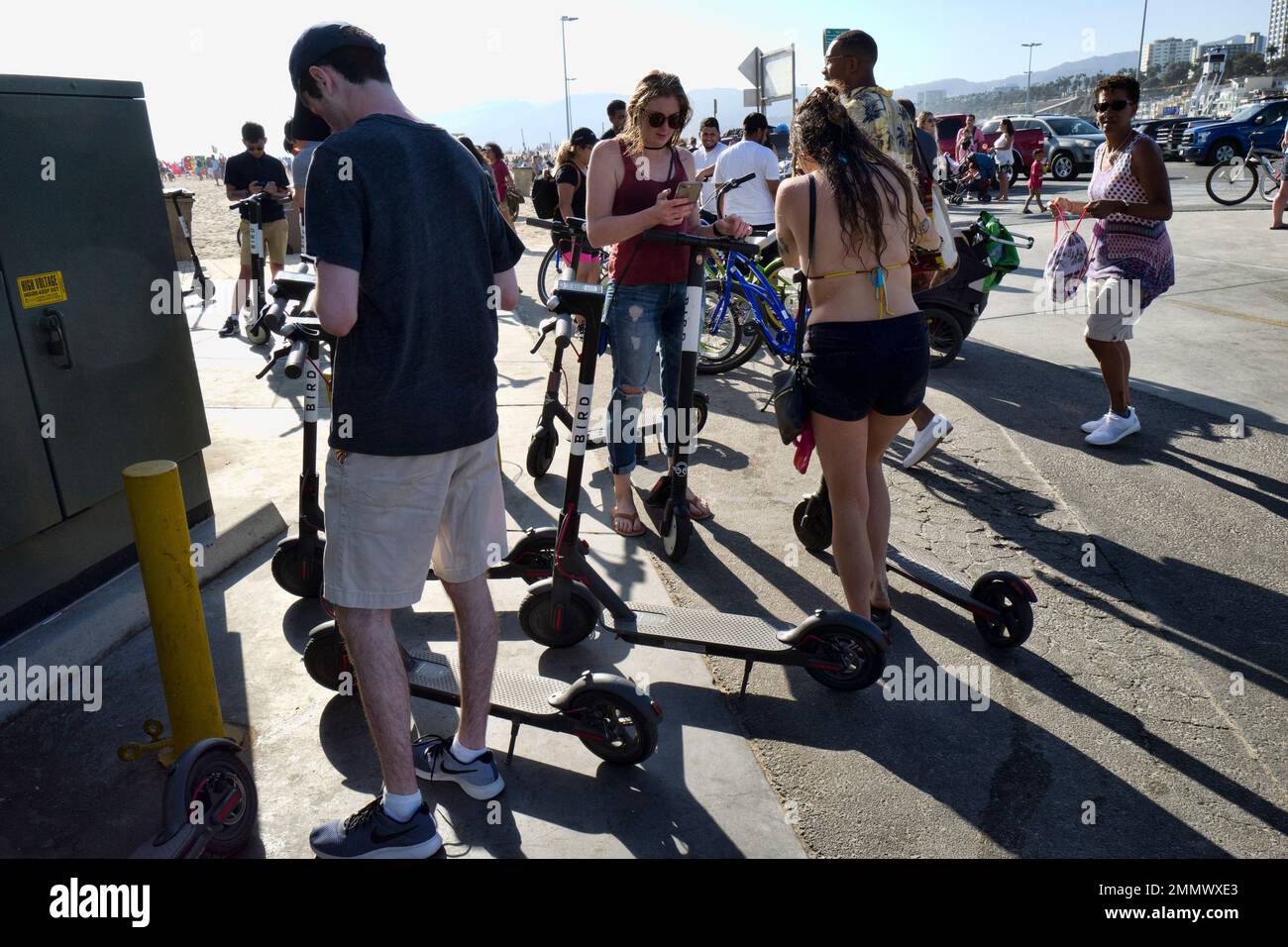 In this July 1, 2018 photo people scan a QR code with an application to ...