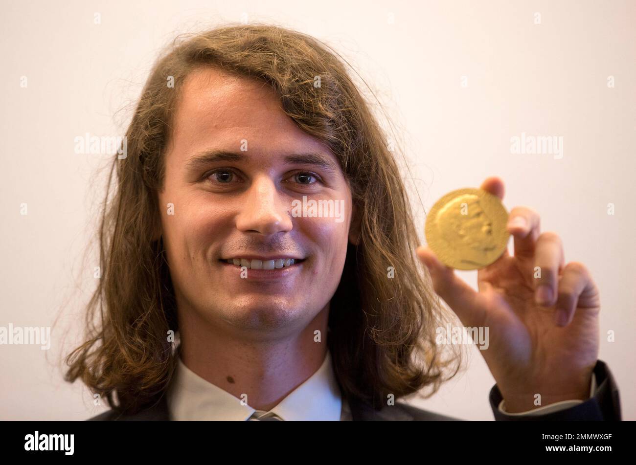 German Peter Scholze shows his medal during a press conference during ...