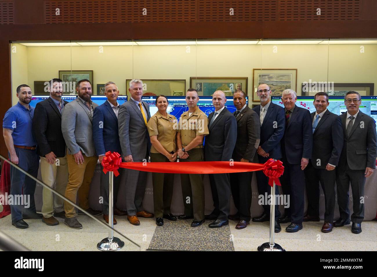 Marine Corps University staff and industry partners pose for a photo ...