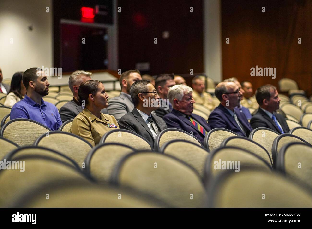U.S. service members and industry partners listen to remarks during the ...