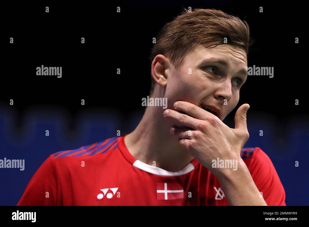 Viktor Axelsen of Denmark reacts while competing against Huang Yuxiang ...