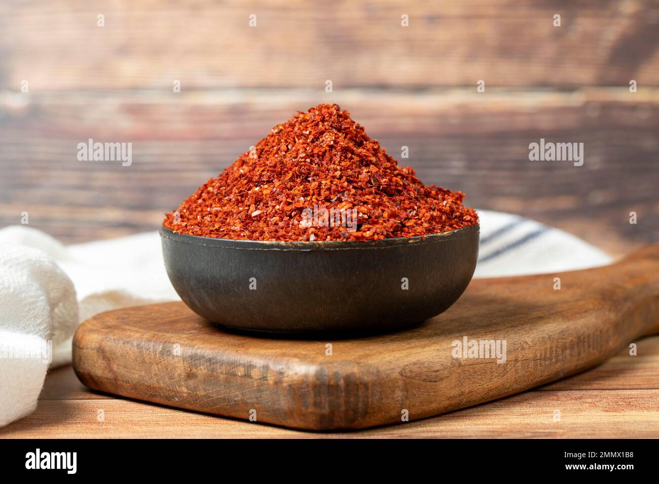 Red pepper flakes. Crushed chili pepper in bowl, dried chili flakes on ...
