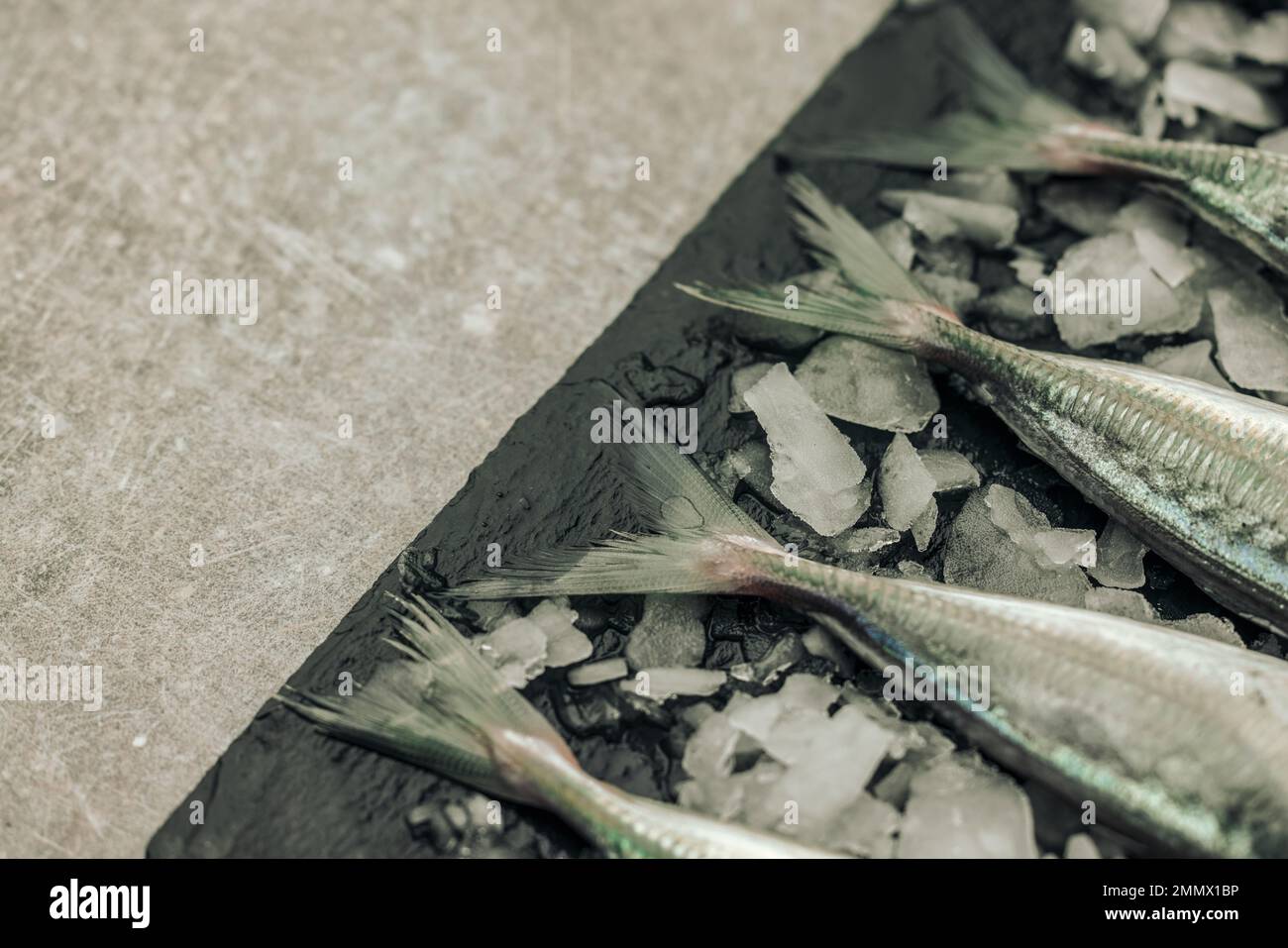 concept of freshness illustrated by uncooked white fish tails on ...