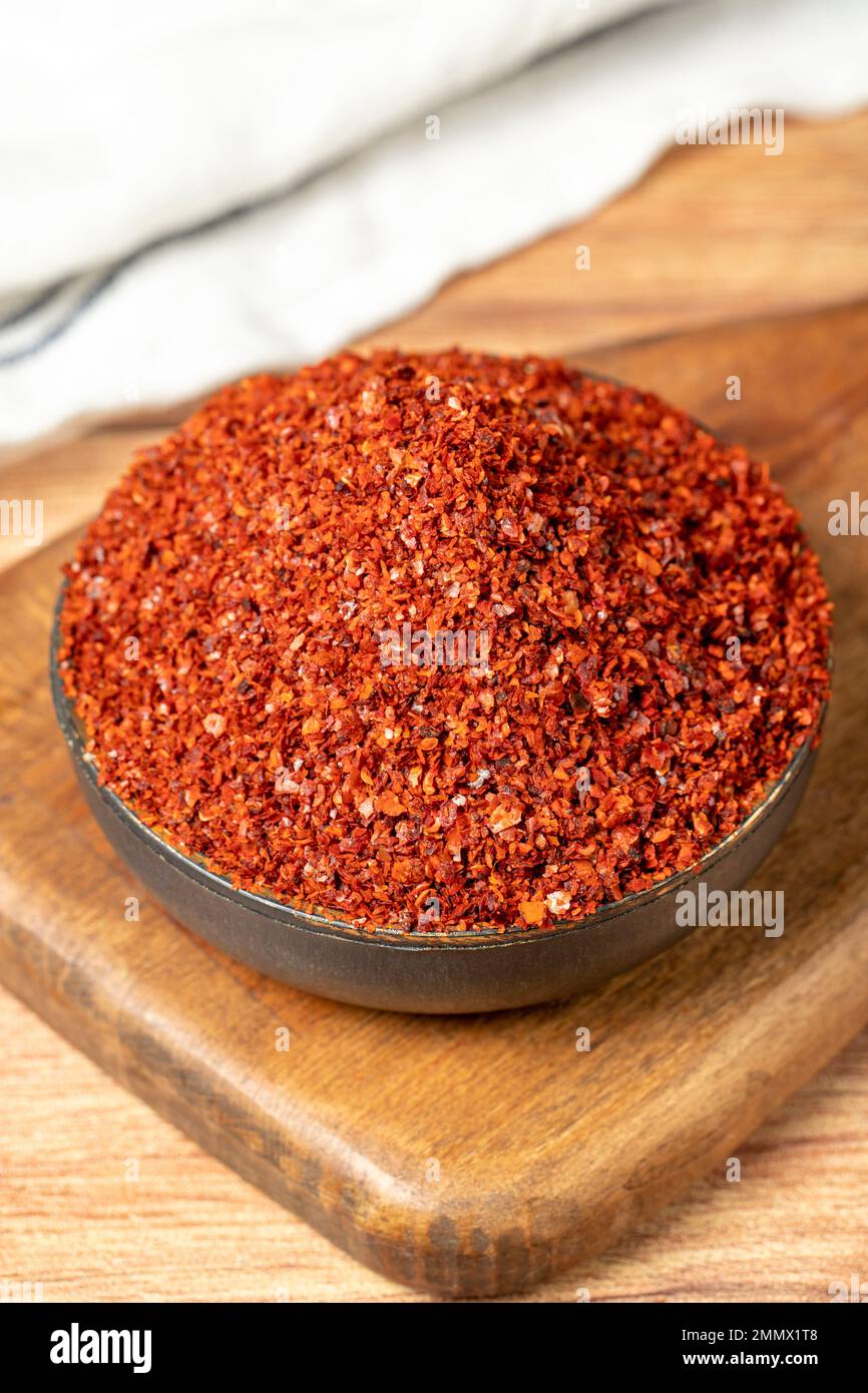 Red pepper flakes. Crushed chili pepper in bowl, dried chili flakes on ...