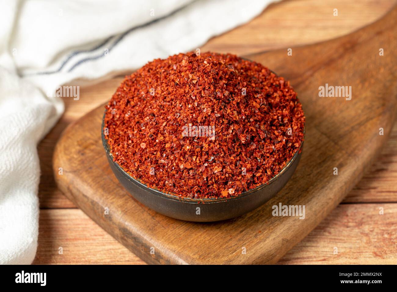 Red pepper flakes. Crushed chili pepper in bowl, dried chili flakes on ...