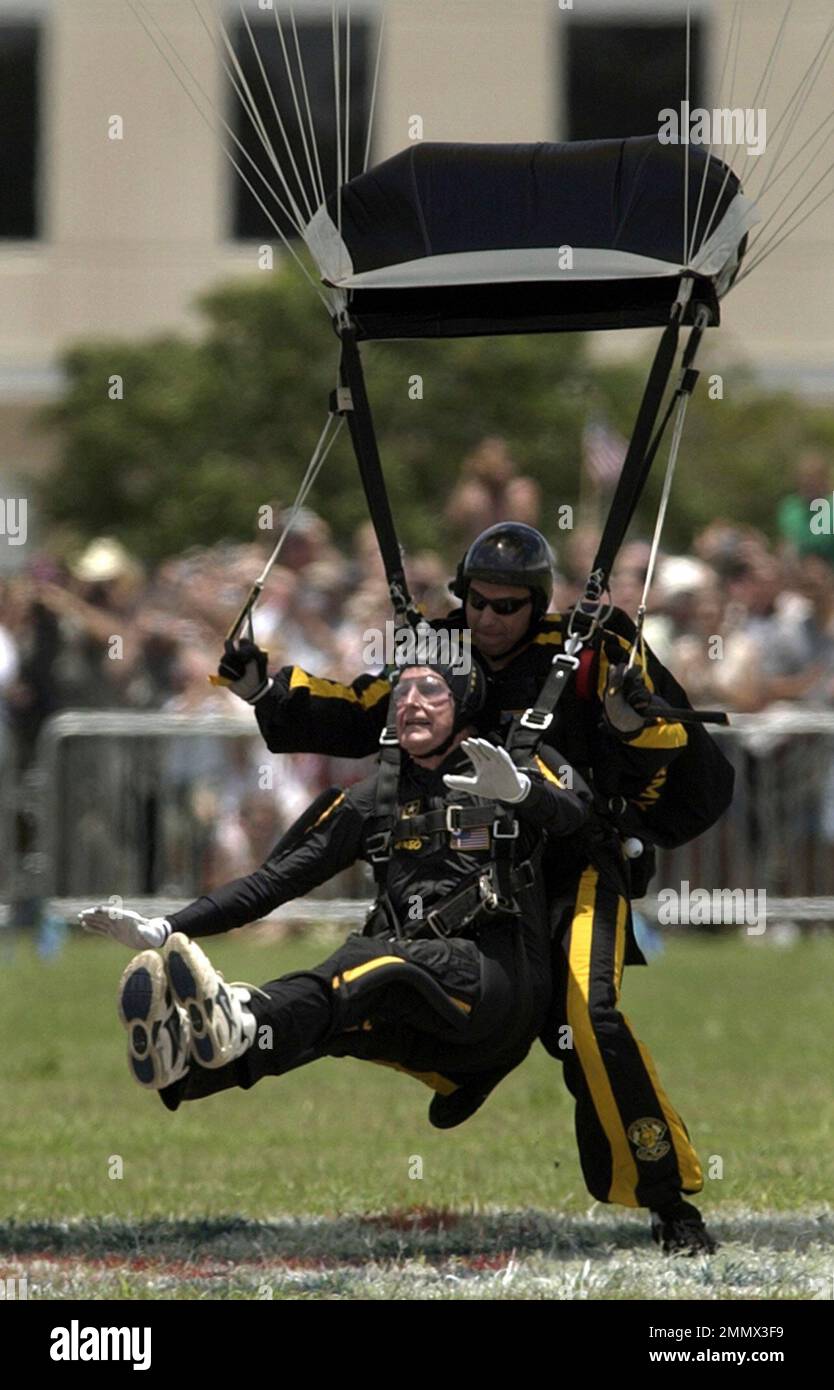 Former President George Bush parachutes to his landing after a tandem ...