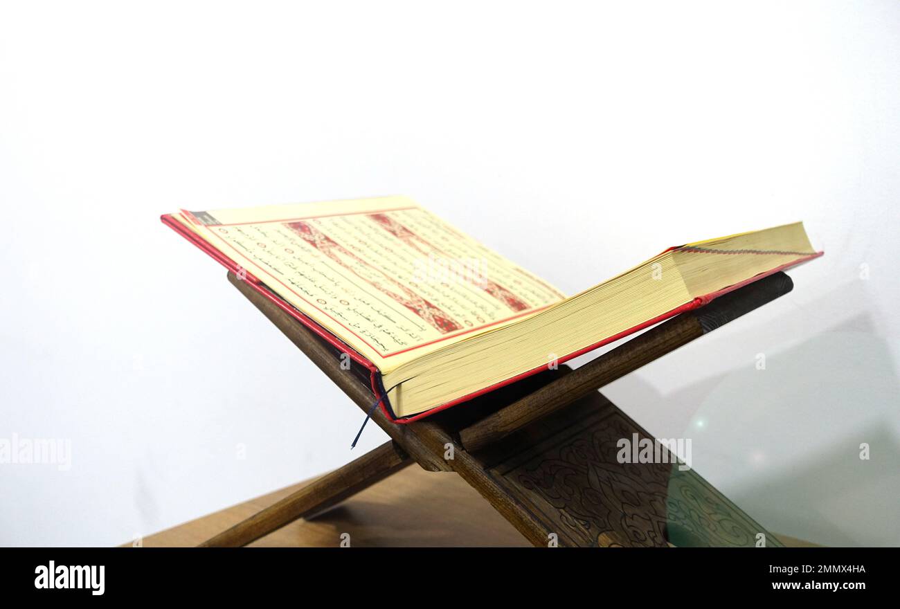 The holy book of Islam, the Holy Quran, on a wooden lectern, the open ...