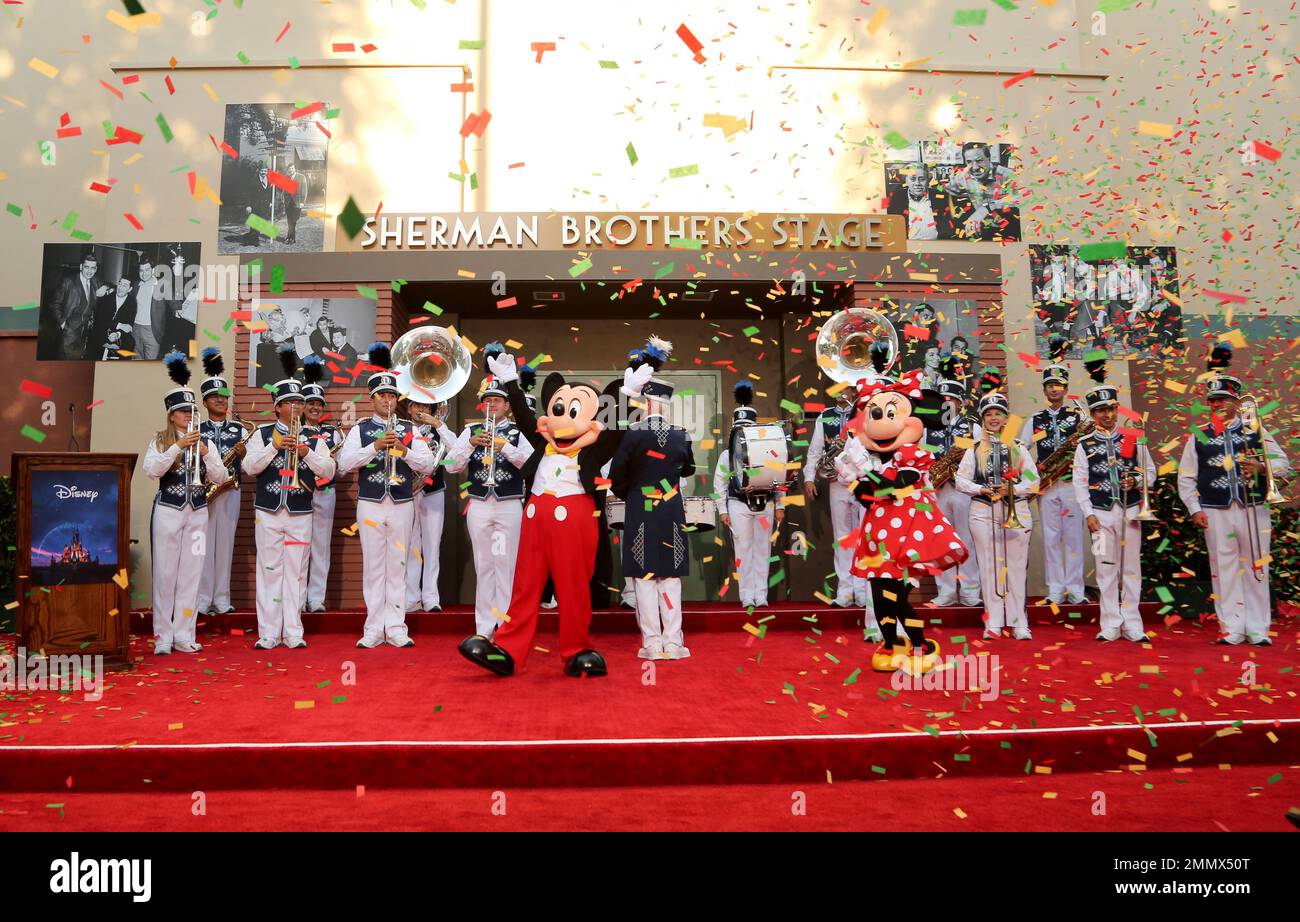 Mickey and Minnie Mouse celebrate as the Walt Disney Band plays the ...