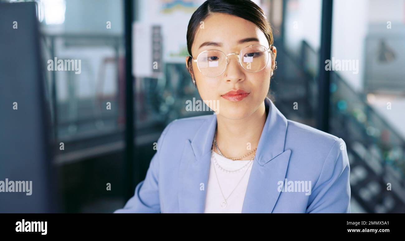 Computer, office and Asian business woman with glasses typing and ...