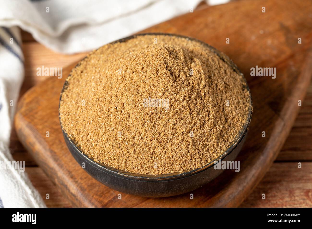 Powdered coriander spice. Coriander powder or dhaniya powder on wooden ...
