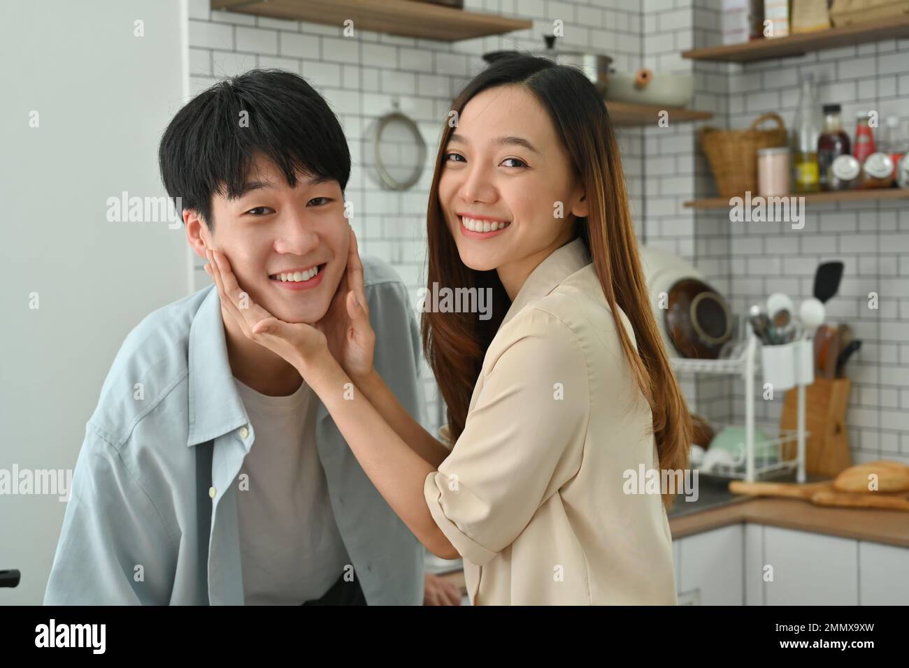 Beautiful young couple enjoying spending time together while standing ...