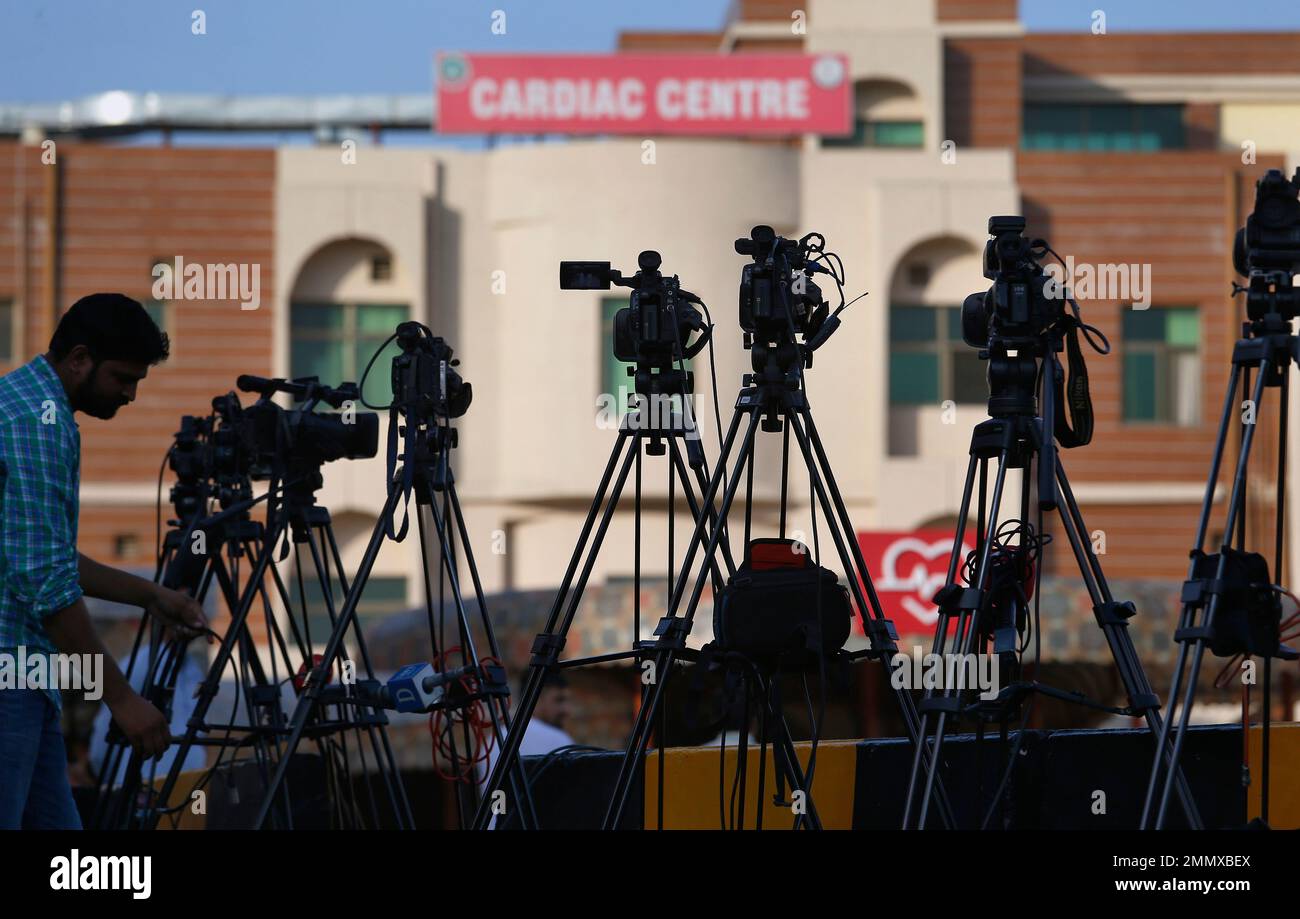 A journalist adjusts his camera outside the cardiac ward where jailed ...