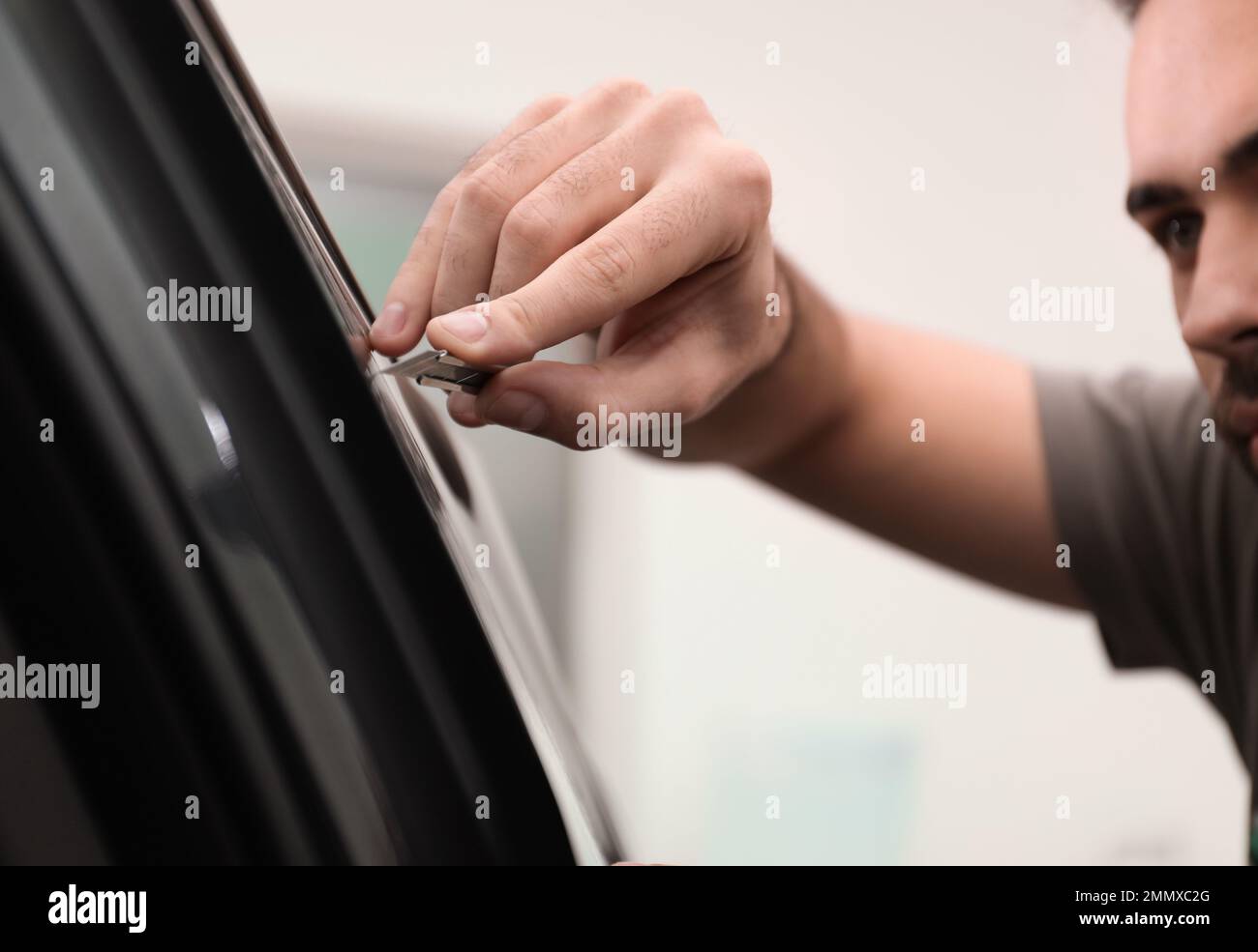 Worker tinting car window with foil in workshop, closeup Stock Photo ...