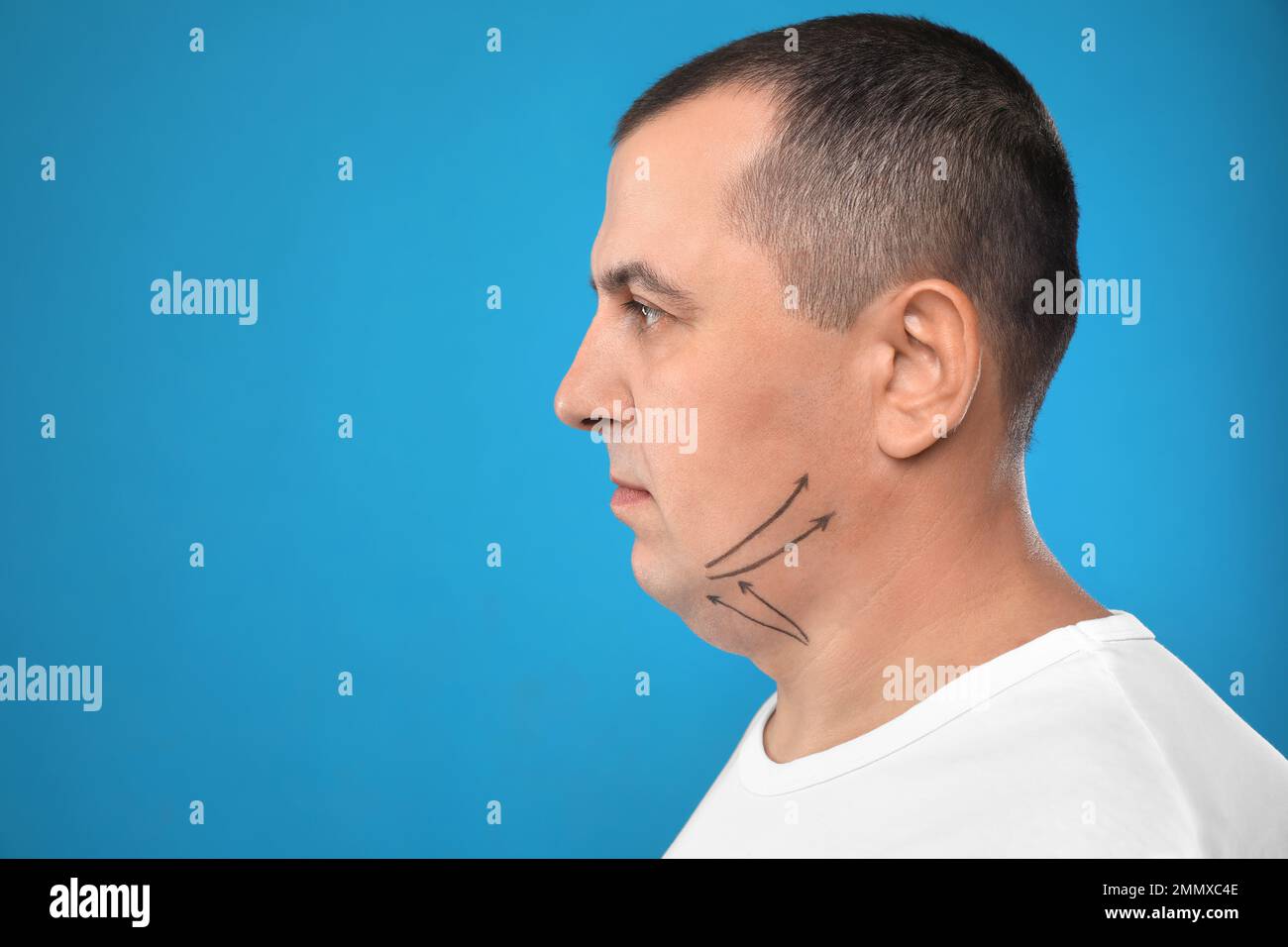 Mature man with marks on face against blue background, space for text ...