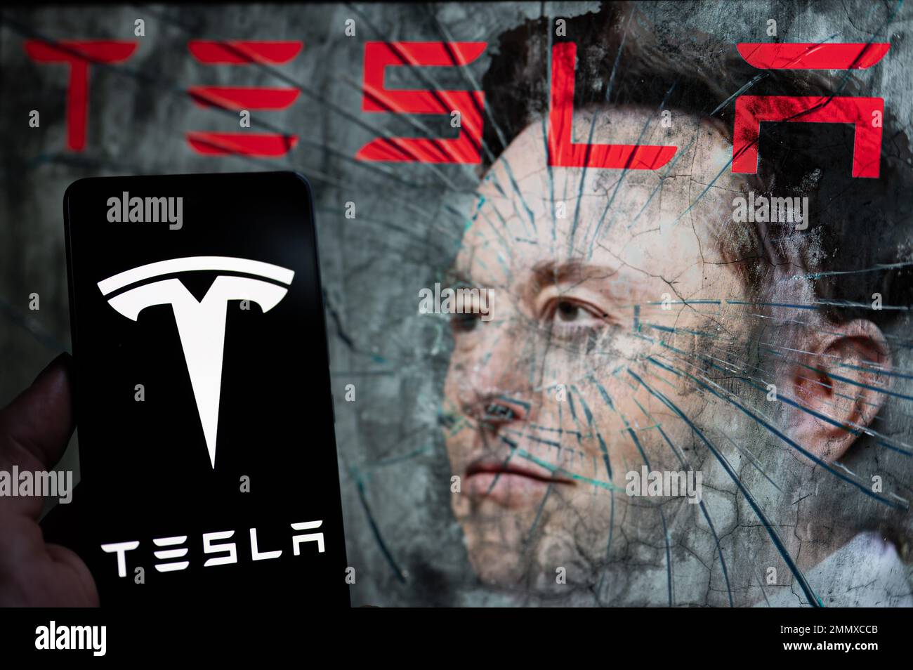 Elon Musk Tesla tweet displayed on mobile with in the background Elon ... Elon Musk Tesla tweet displayed on mobile with in the background Elon ...