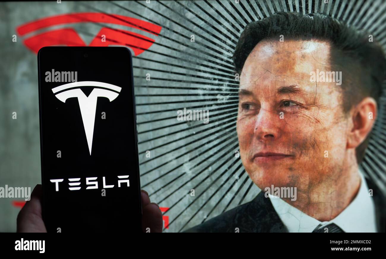 Elon Musk Tesla tweet displayed on mobile with in the background Elon ...