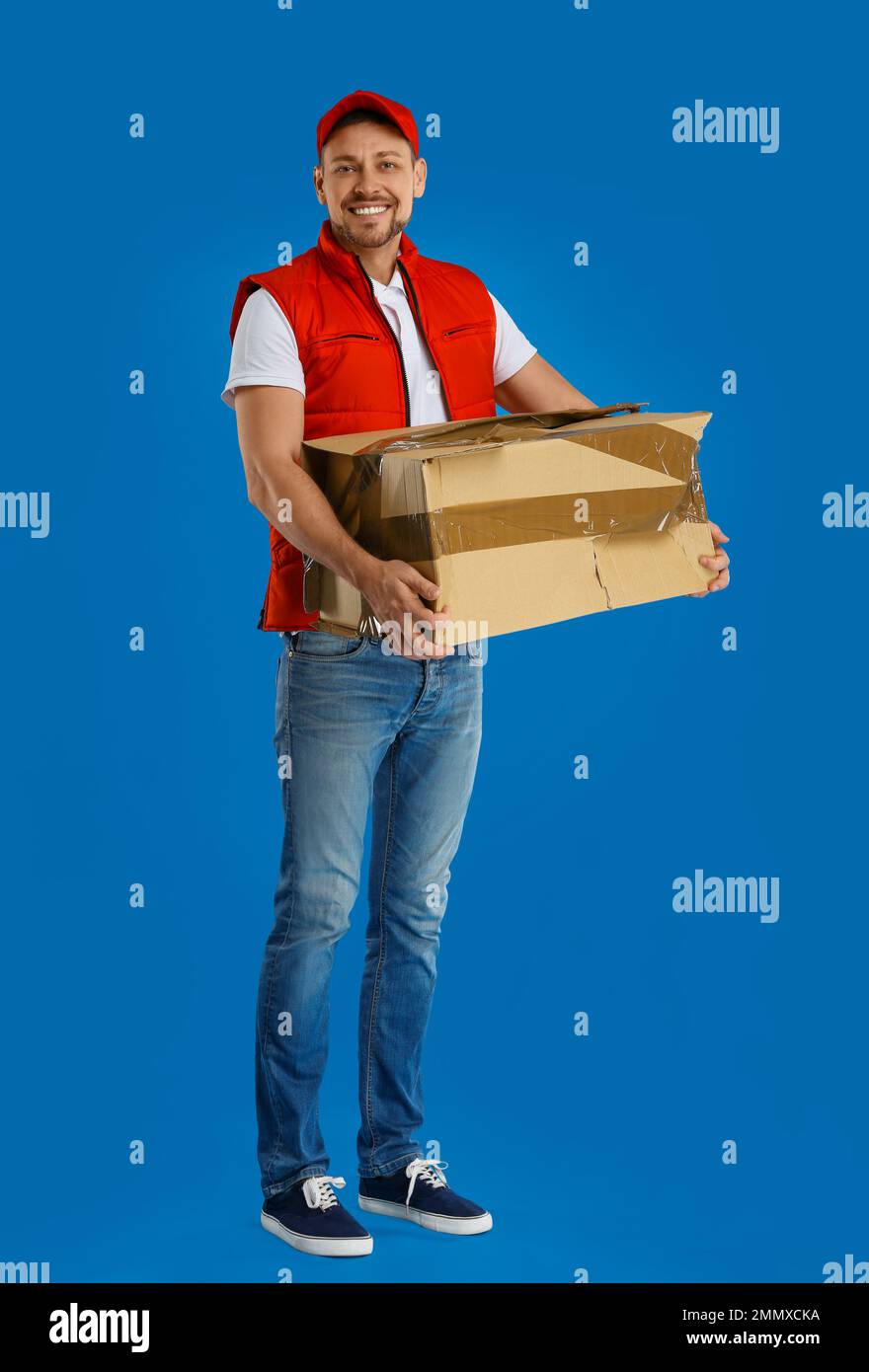 Courier with damaged cardboard box on blue background. Poor quality ...