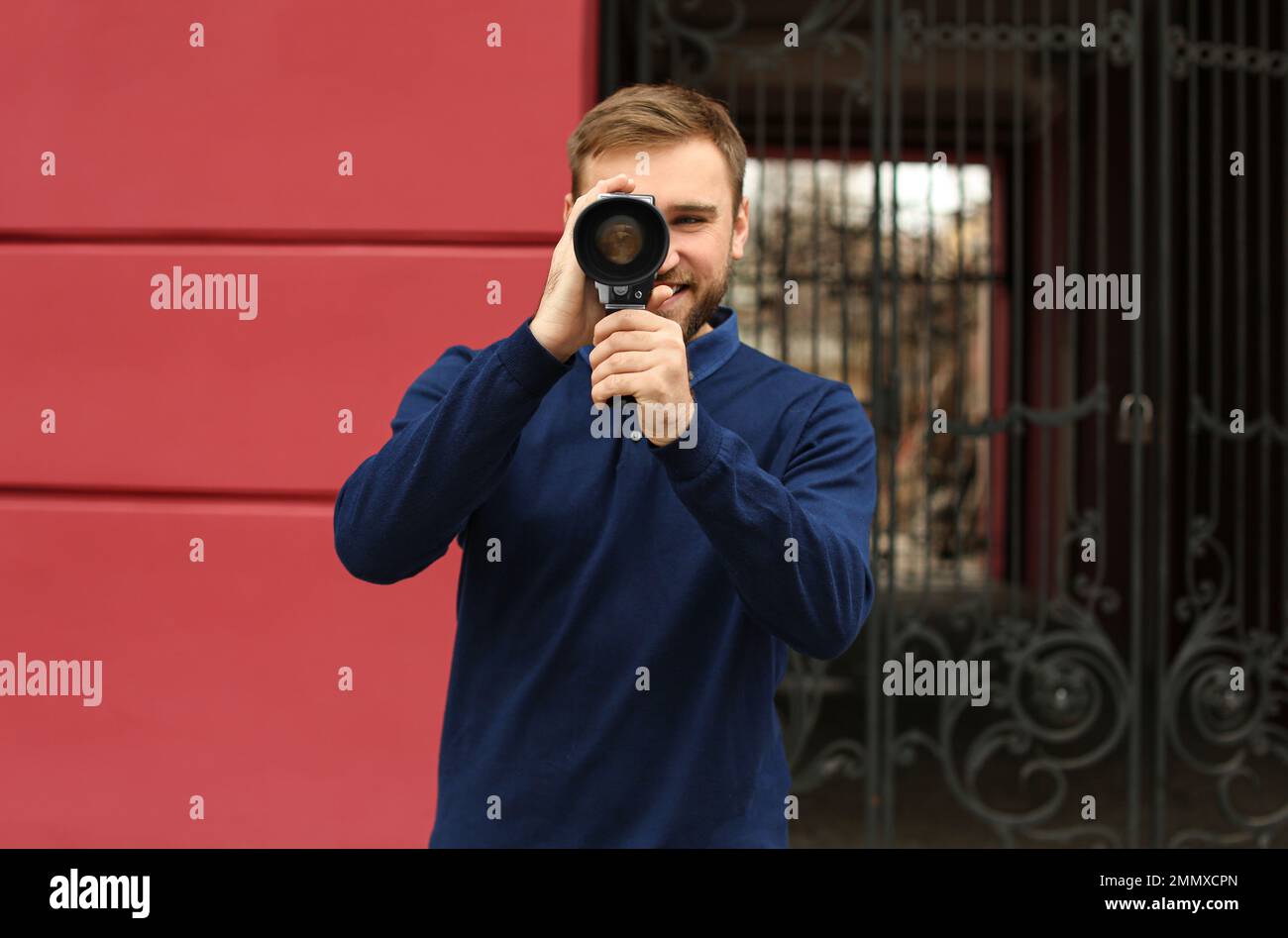 Young man using vintage video camera outdoors Stock Photo - Alamy