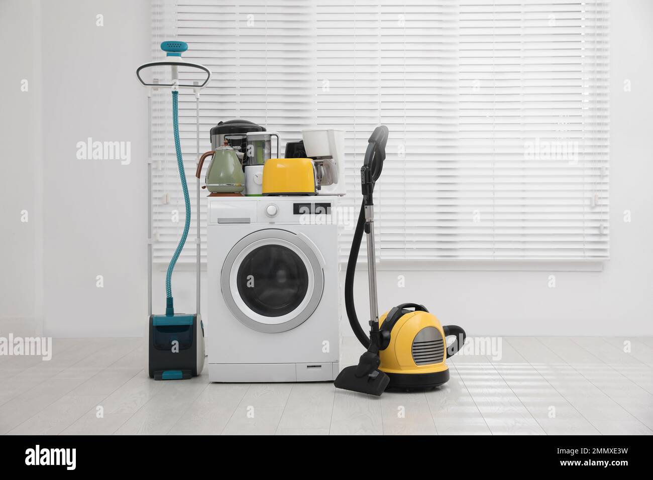 Different household appliances near window in room Stock Photo - Alamy