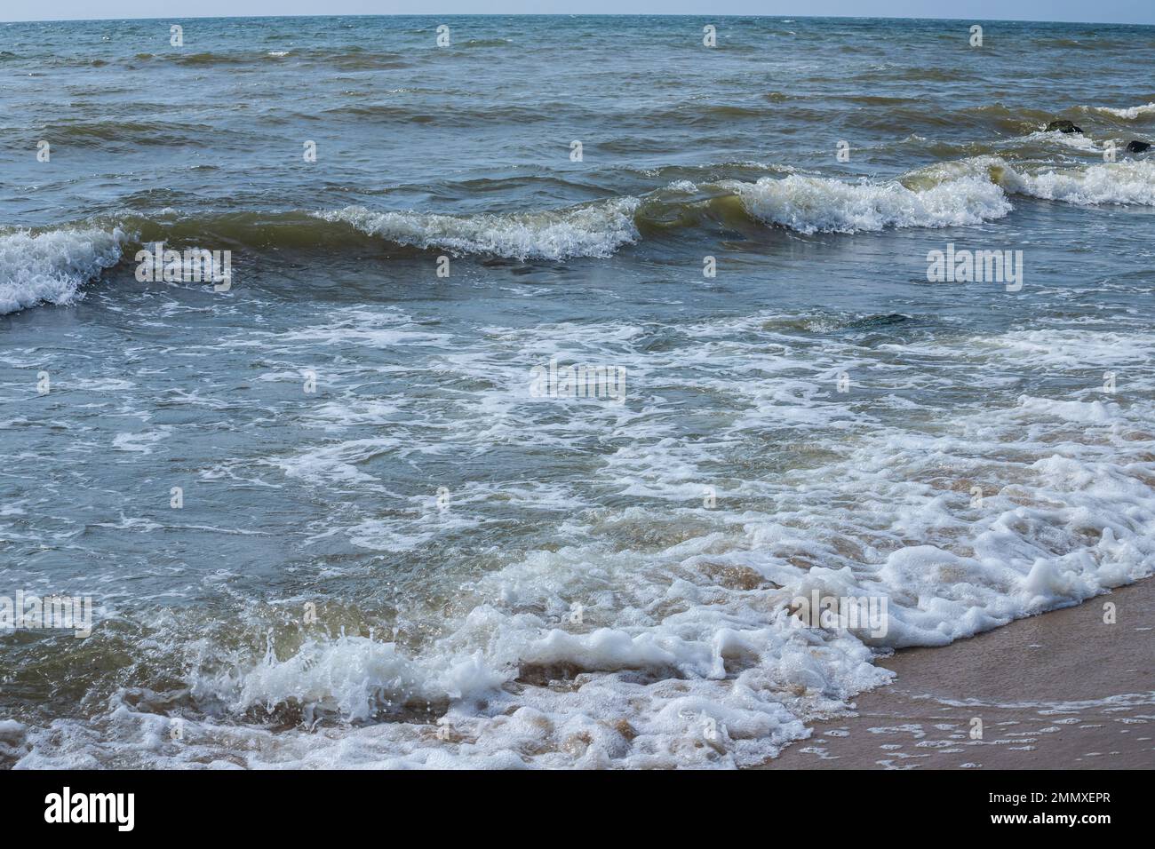 Sea wave with spray and foam near the shore Stock Photo - Alamy