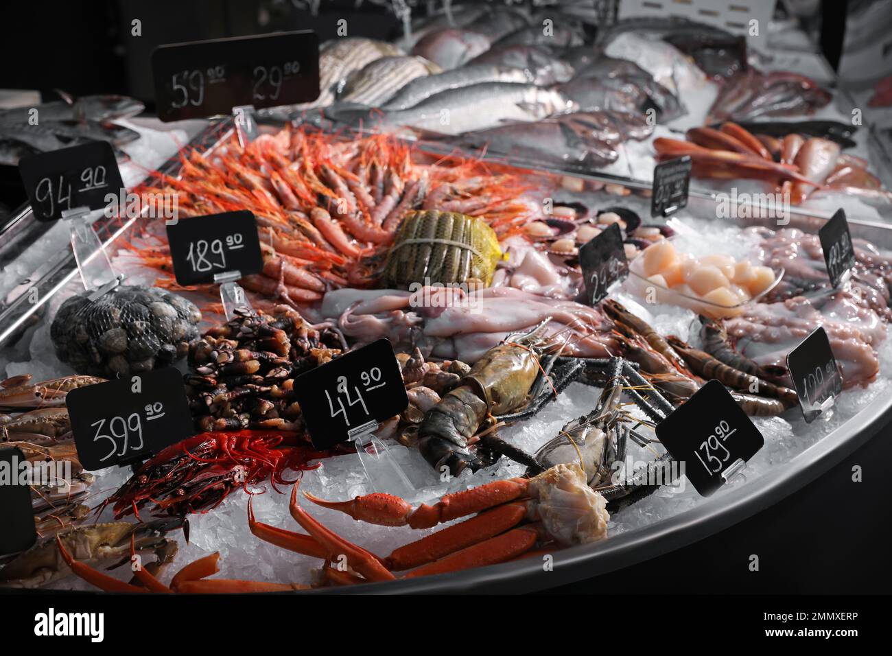 Different types of fresh seafood on ice in supermarket Stock Photo - Alamy