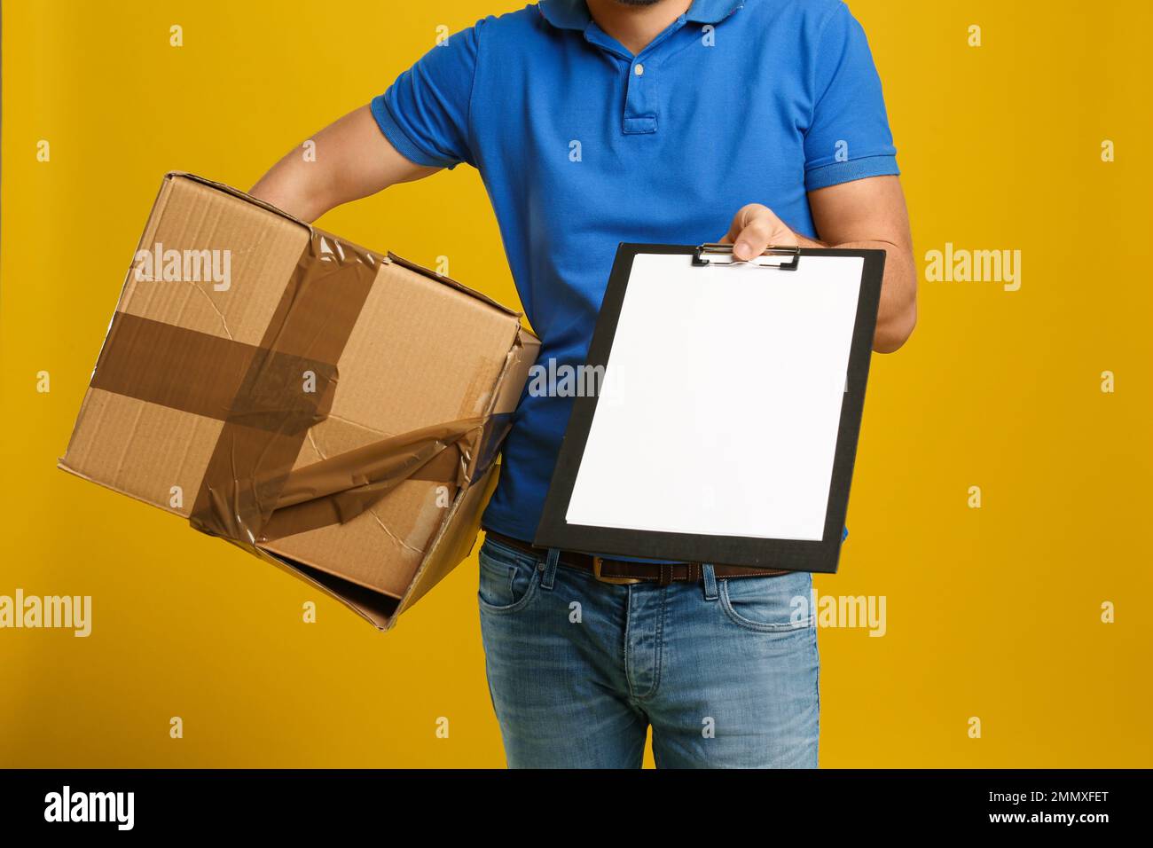 Courier with damaged cardboard box and clipboard on yellow background ...