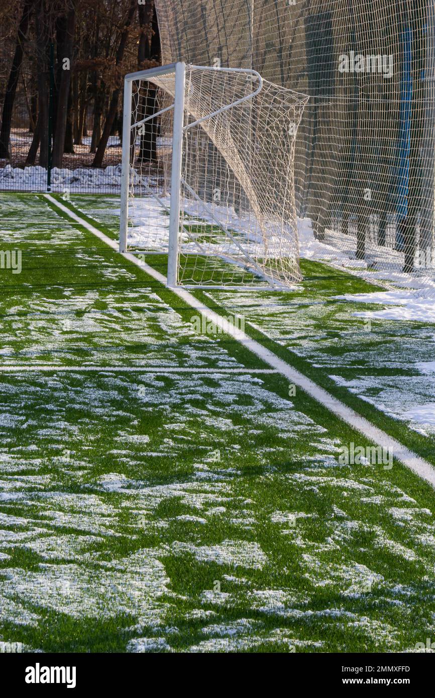 field for playing football in winter, artificial grass on cleared of ...
