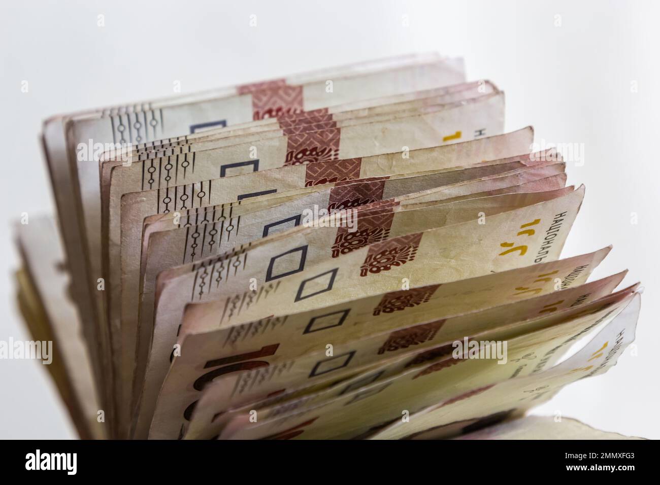 Ukrainian paper money is laid out on a blue background. 100 hryvnia ...