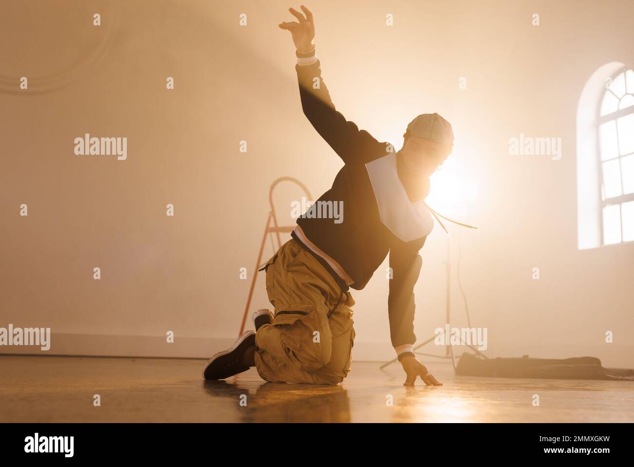 Image of biracial male hip hop dancer dancing in smoked interior. Dance ...