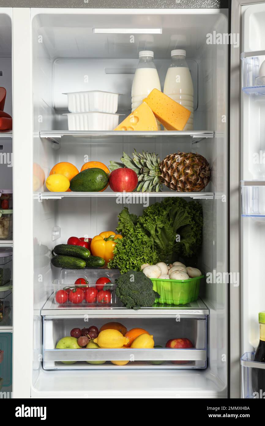 Open refrigerator full of different fresh products Stock Photo - Alamy