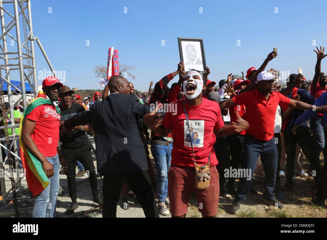 An opposition party supporter celebrates after seeing Nelson Chamisa ...