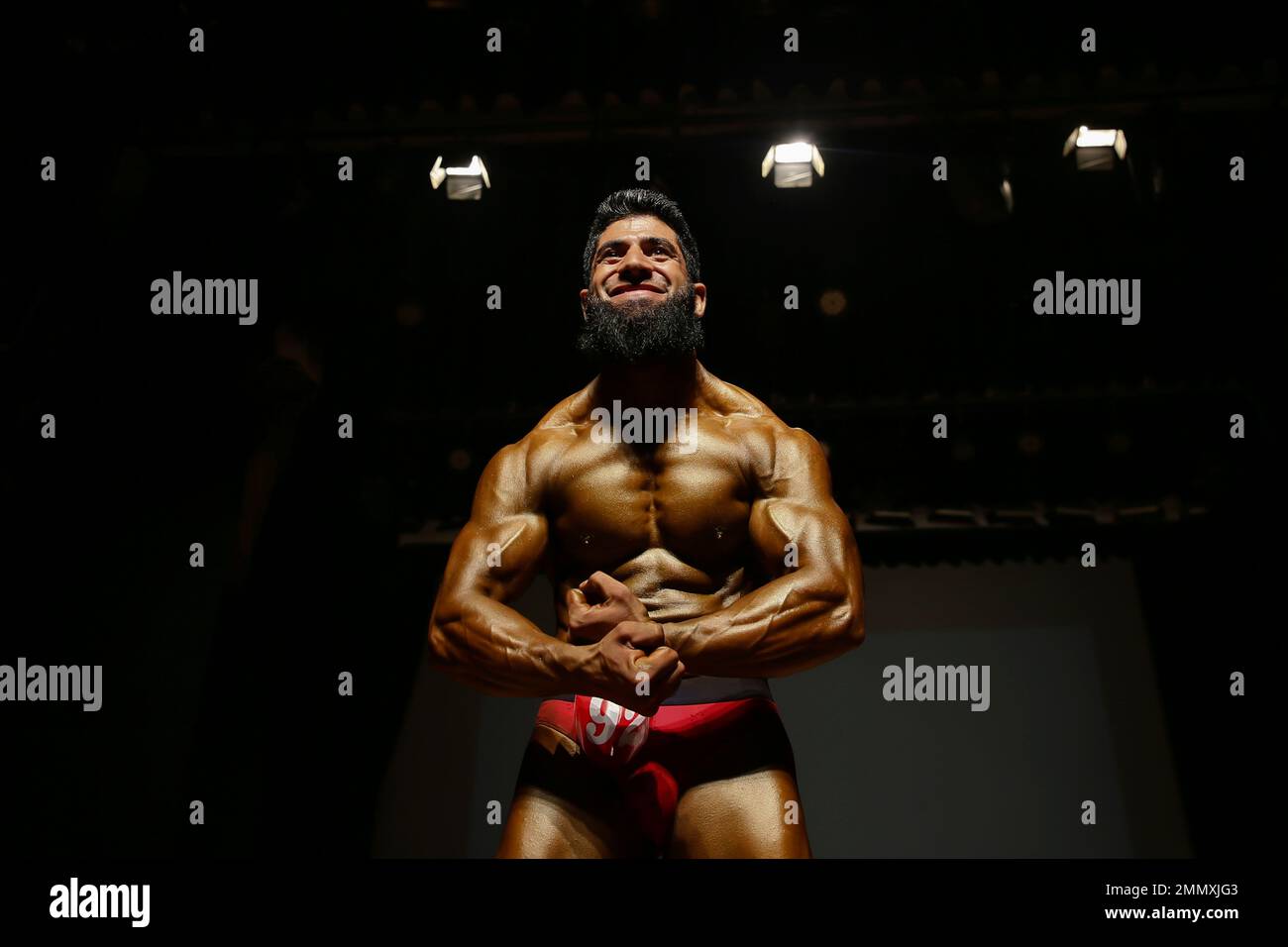 A Kashmiri bodybuilder displays his muscles at a bodybuilding ...