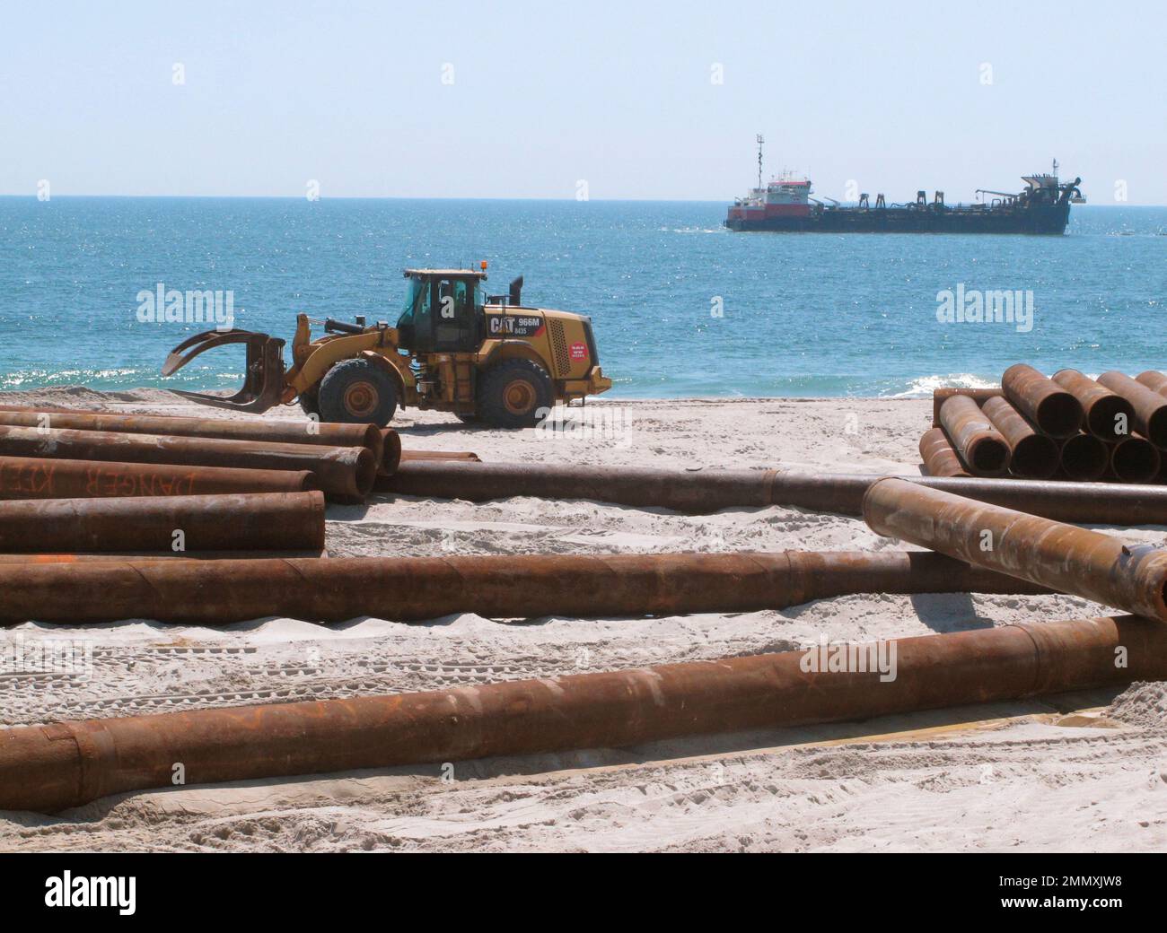 This July 11, 2018 photo shows a ship pumping sand from offshore onto ...