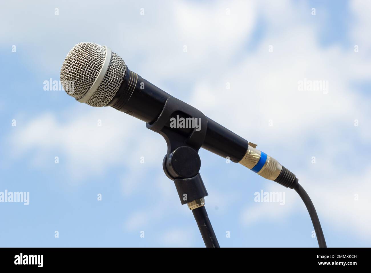 Microphone on sky background. The microphone is on the street. Concept ...