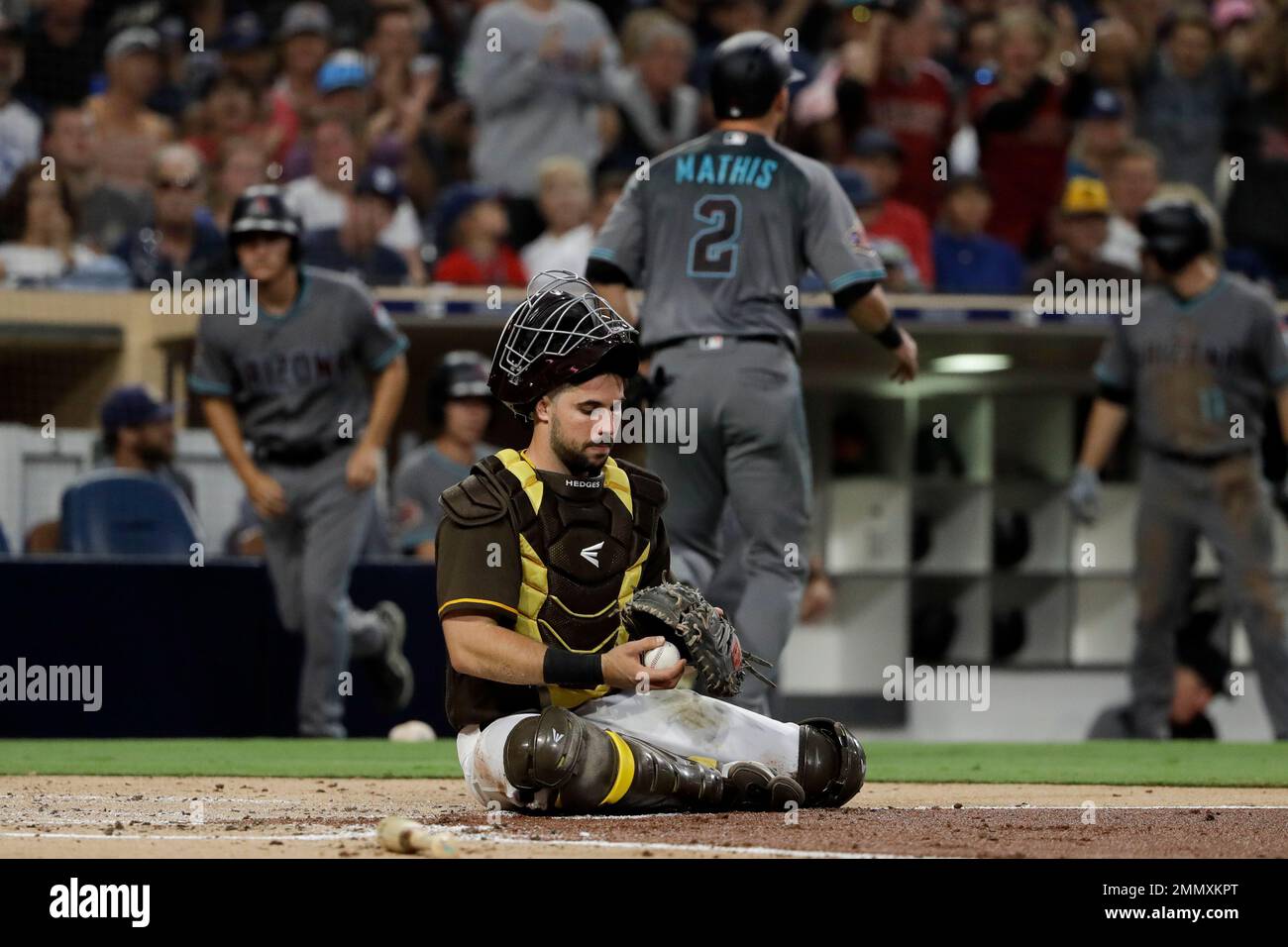 San Diego Padres catcher Austin Hedges, bottom, looks on after Arizona ...