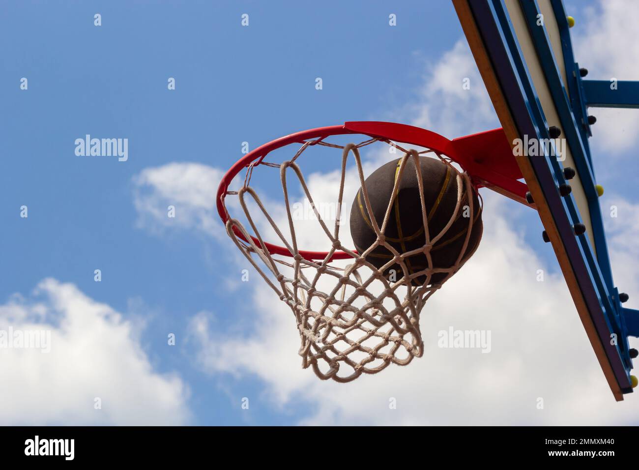 A basketball in the net. The fly ball is in the ring. A sports game ...