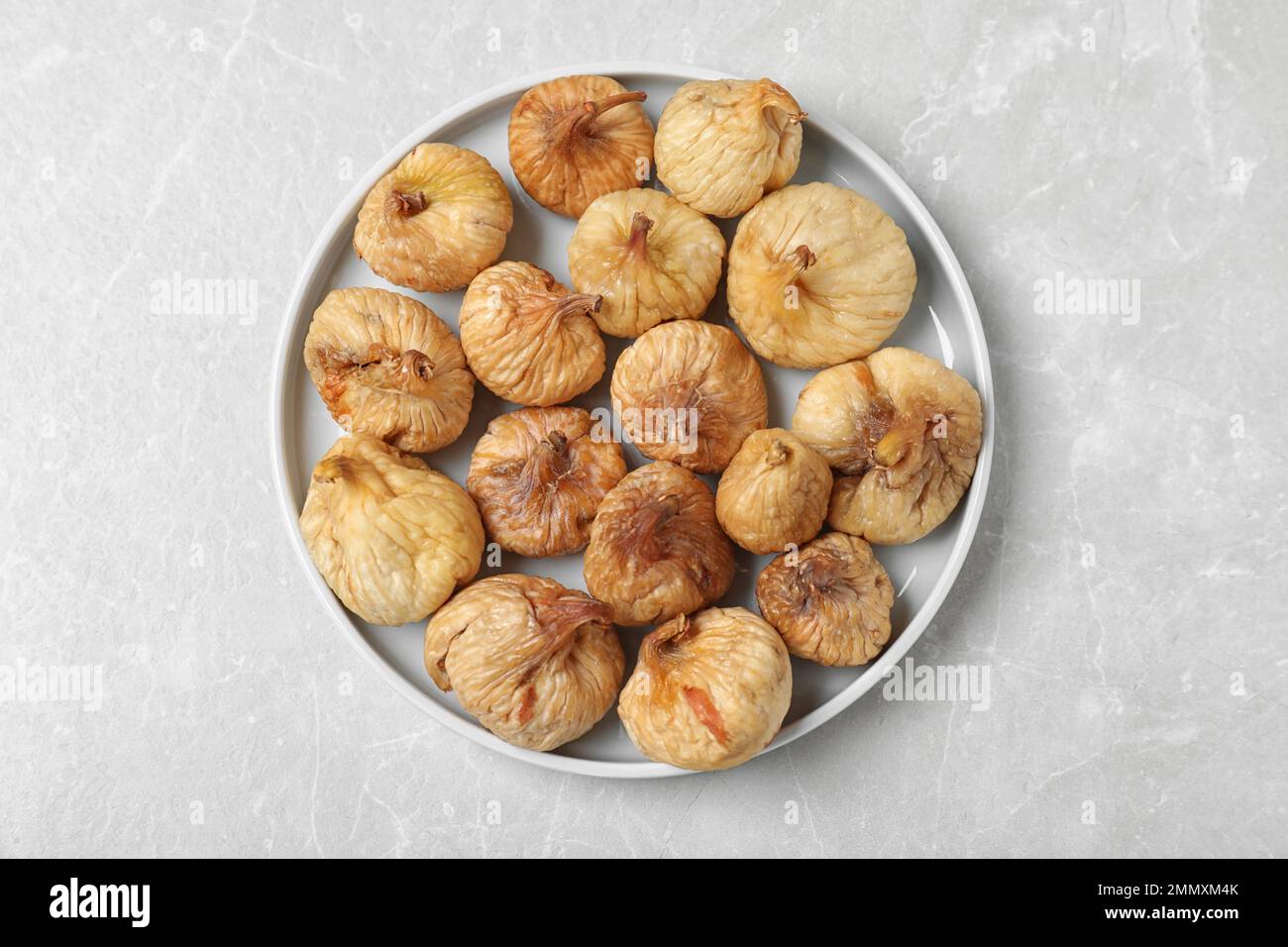 Tasty dried figs on light grey marble table, top view Stock Photo - Alamy