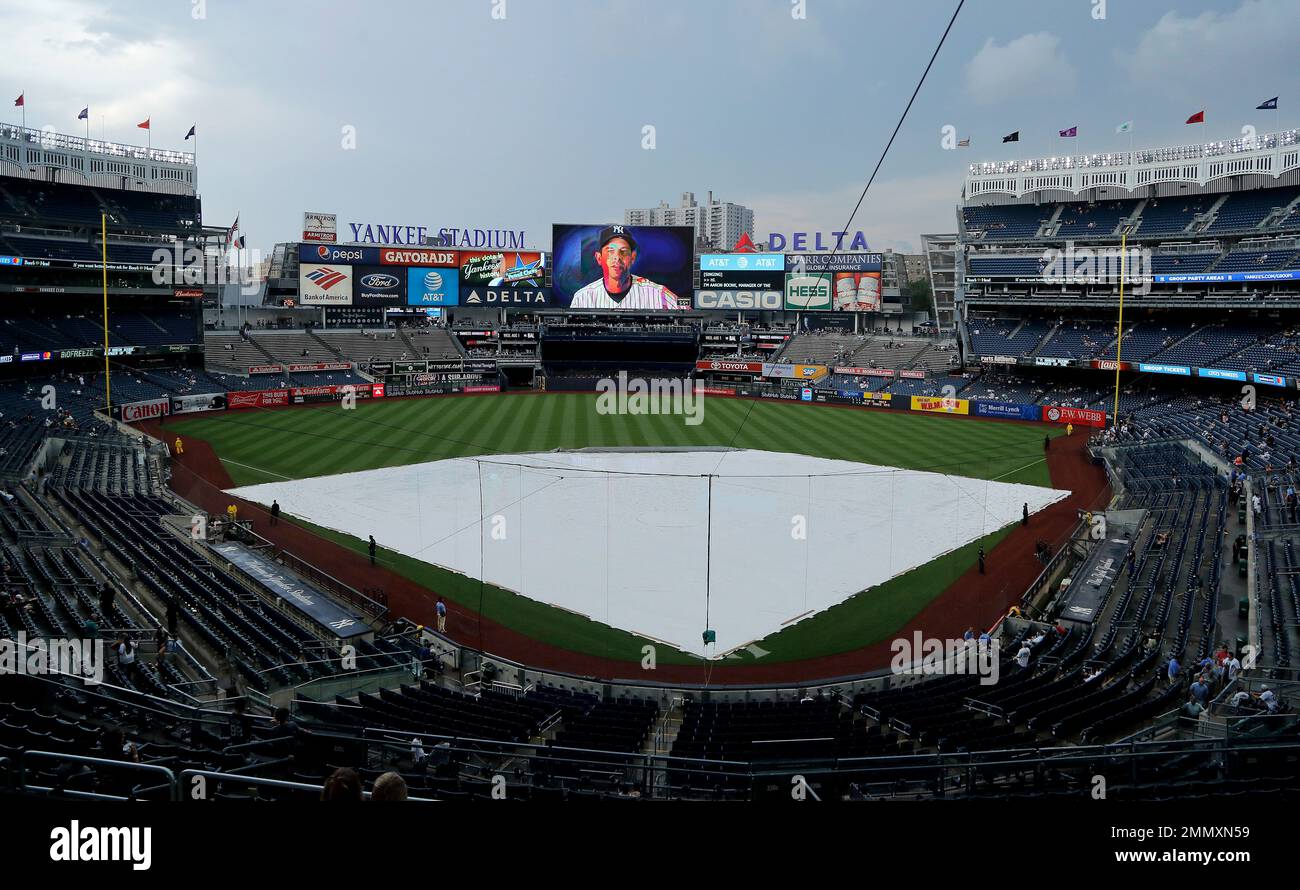 The tarp covers the field during a rain delay at a baseball game ...