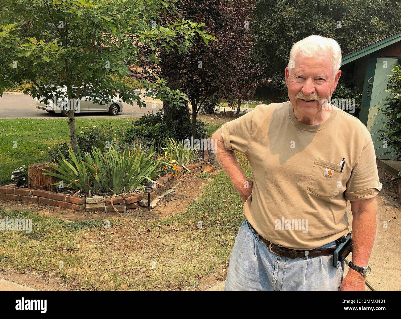 Jim Chapin poses for photos while interviewed outside his home, which ...