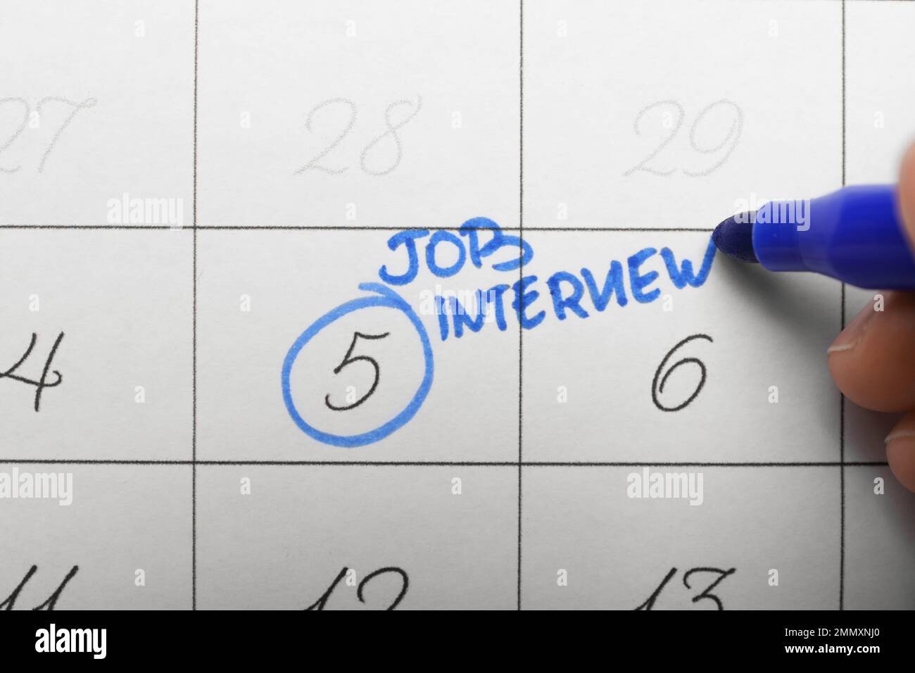 Woman marking date of job interview in calendar, closeup Stock Photo ...
