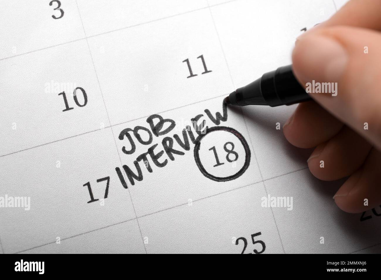Woman marking date of job interview in calendar, closeup Stock Photo ...