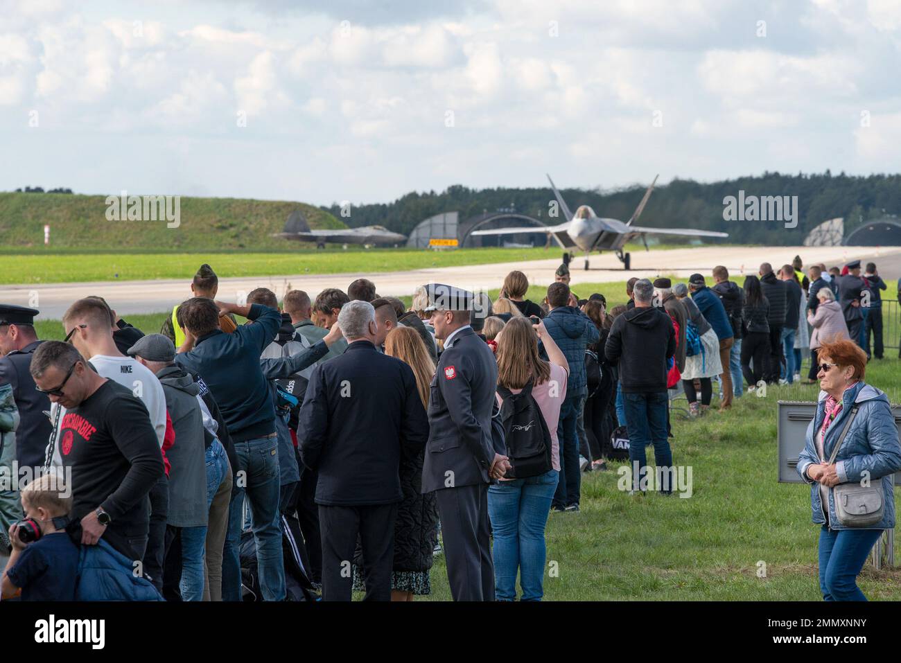 Polish military and community members watch as two U.S. Air Force F-22 ...