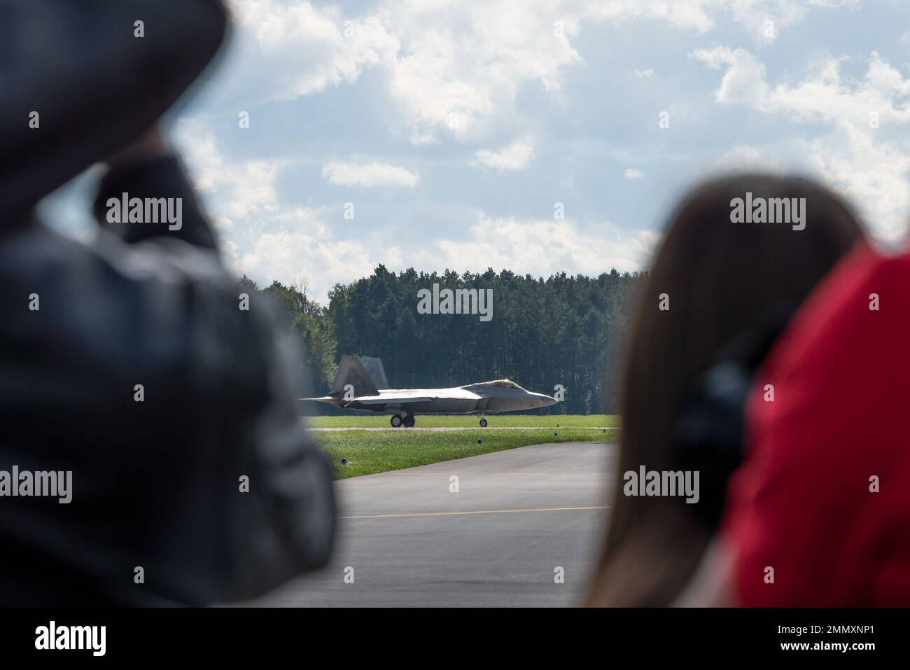 Polish military and community members watch as two U.S. Air Force F-22 ...