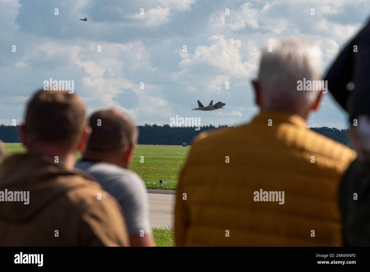 Polish military and community members watch as two U.S. Air Force F-22 ...