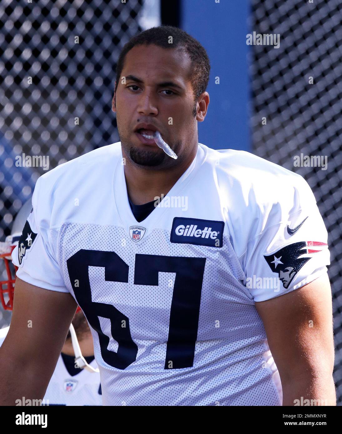 New England Patriots tackle Ulrick John chews on his mouth guard as he ...