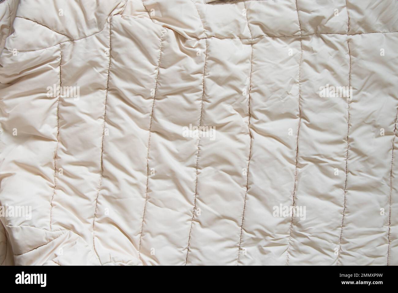 women's padded white soft jacket as background, background of soft ...
