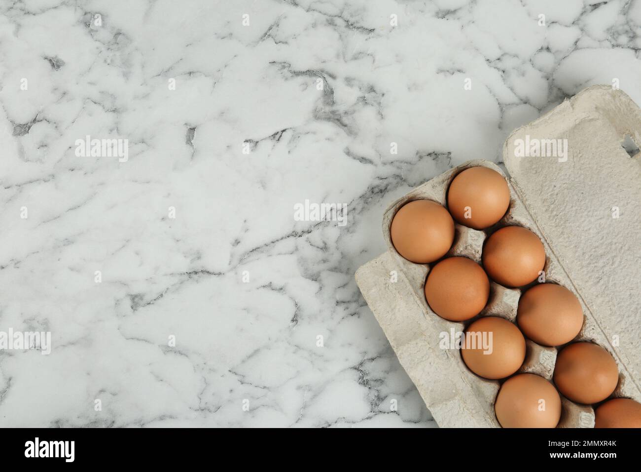 Raw chicken eggs on white marble table, top view. Space for text Stock ...