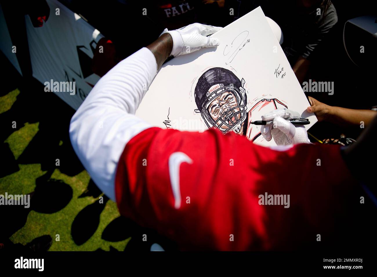 Atlanta Falcons wide receiver Calvin Ridley autographs a caricature of ...